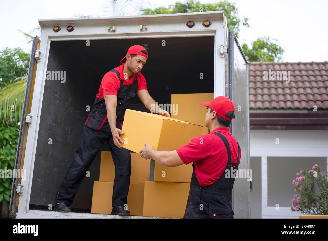 Delivery man move items to the house. Service and delivery concept ...