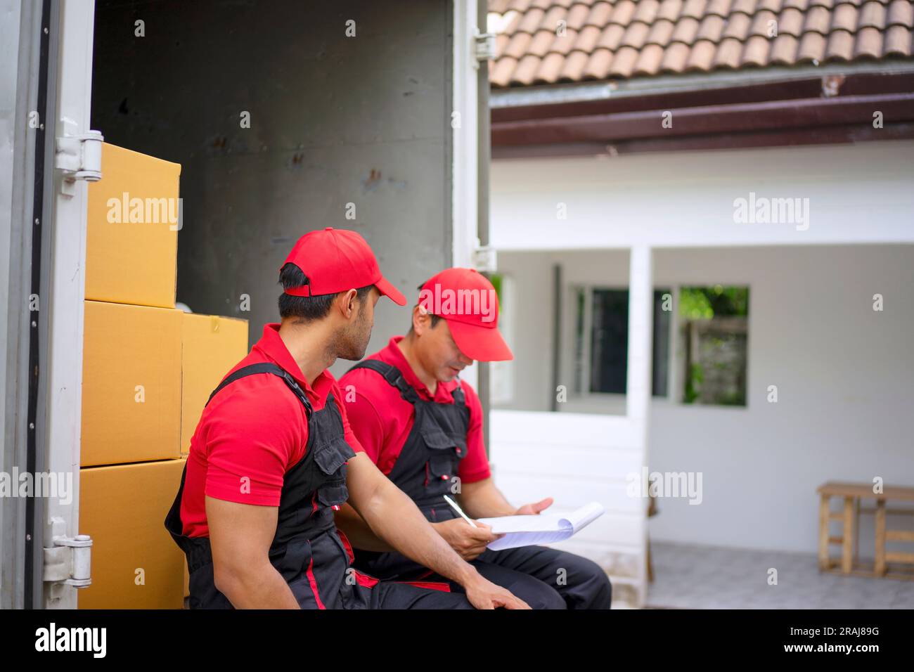Delivery man move items to the house. Service and delivery concept ...