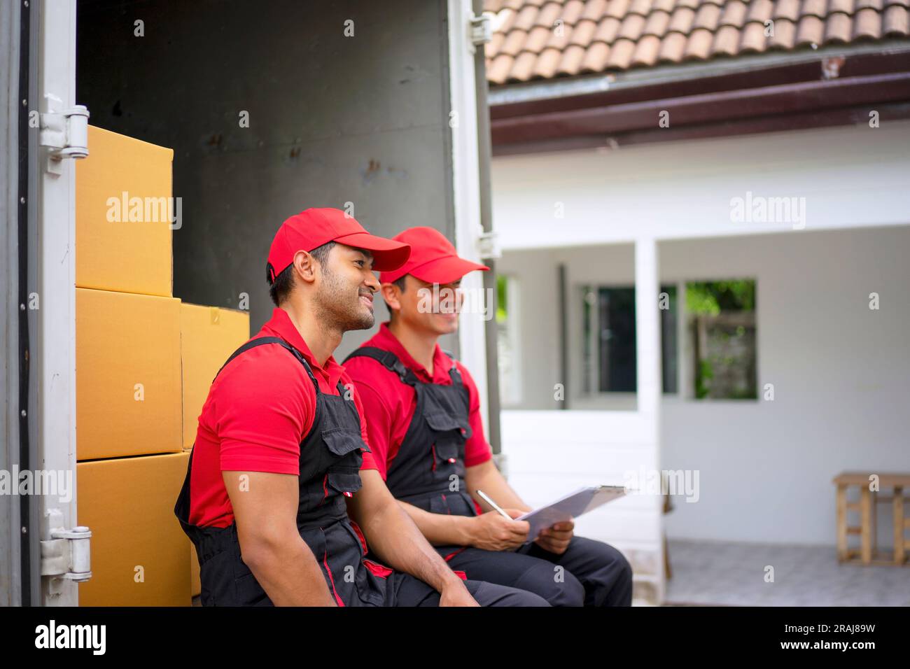 Delivery man move items to the house. Service and delivery concept ...