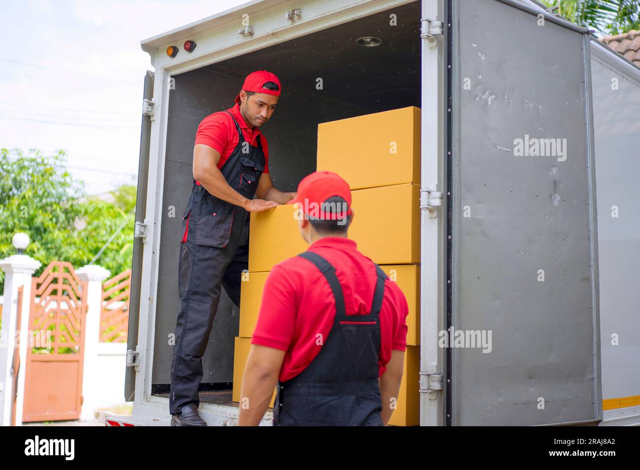 Delivery man move items to the house. Service and delivery concept ...