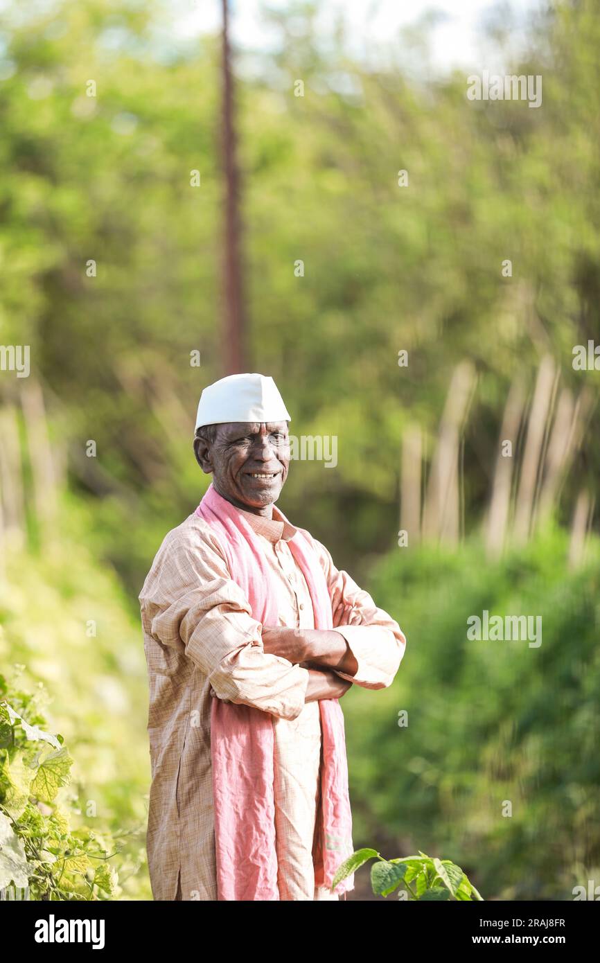 Indian farming Happy indian farmer standing in farm, sowing Empty Hands ...