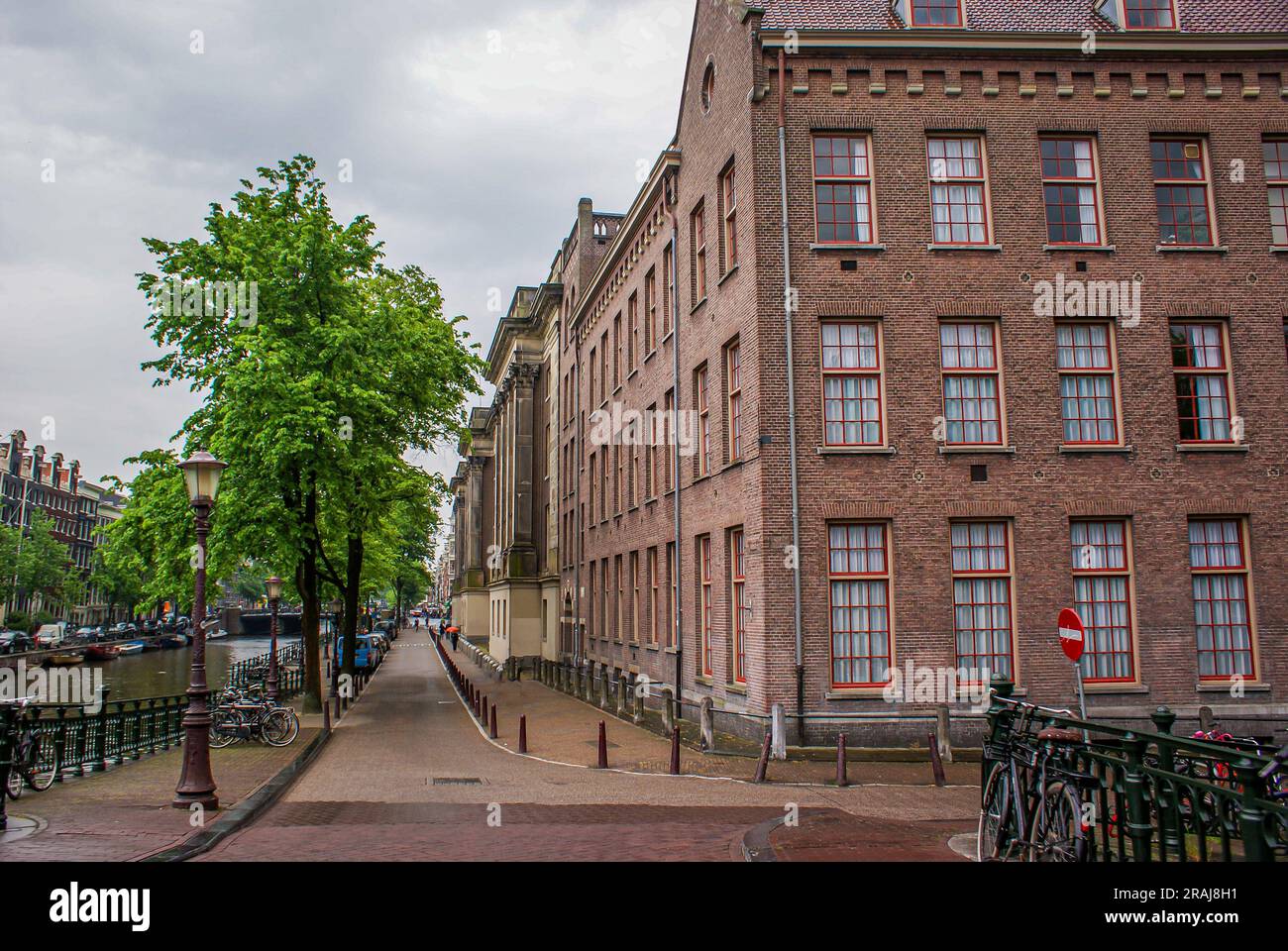 a large brick building next to a road Stock Photo - Alamy
