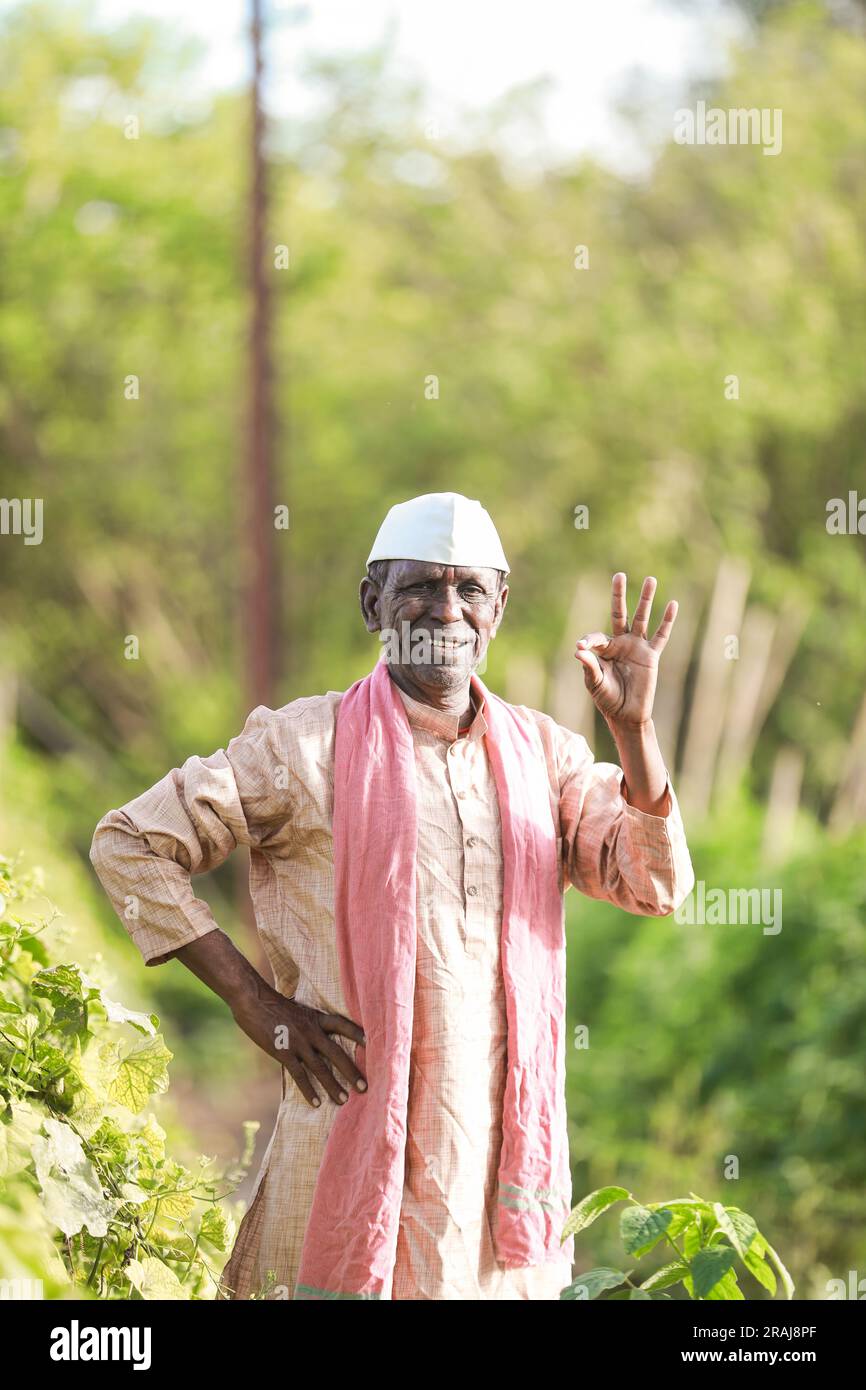 Indian farming Happy indian farmer standing in farm, sowing Empty Hands ...