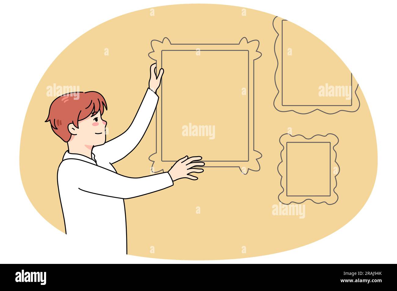 Man hanging frames with family pictures on wall. Happy male putting ...
