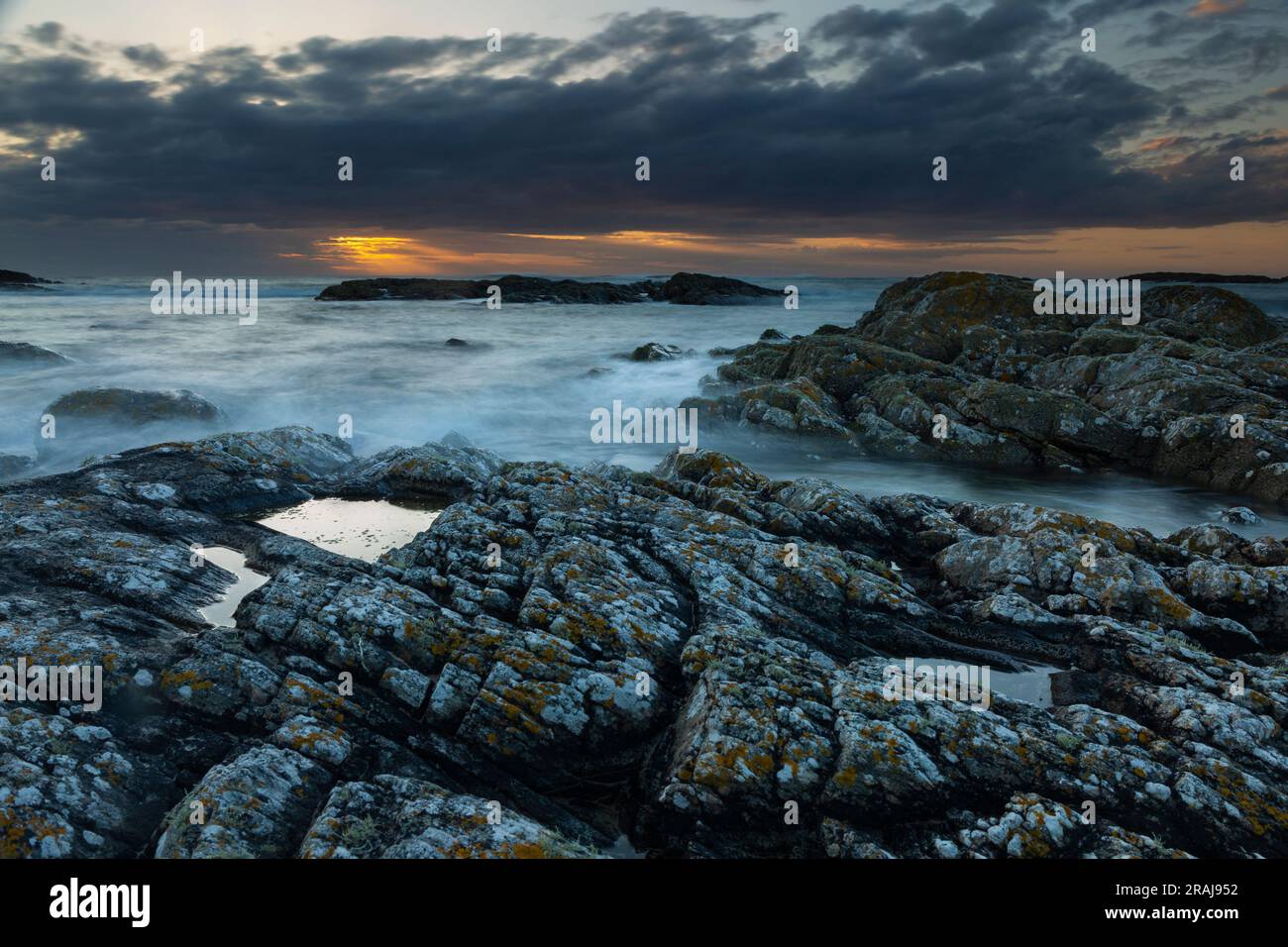 Landscape view of sunset over rocky shoreline, Coll, Scotland, UK, May ...