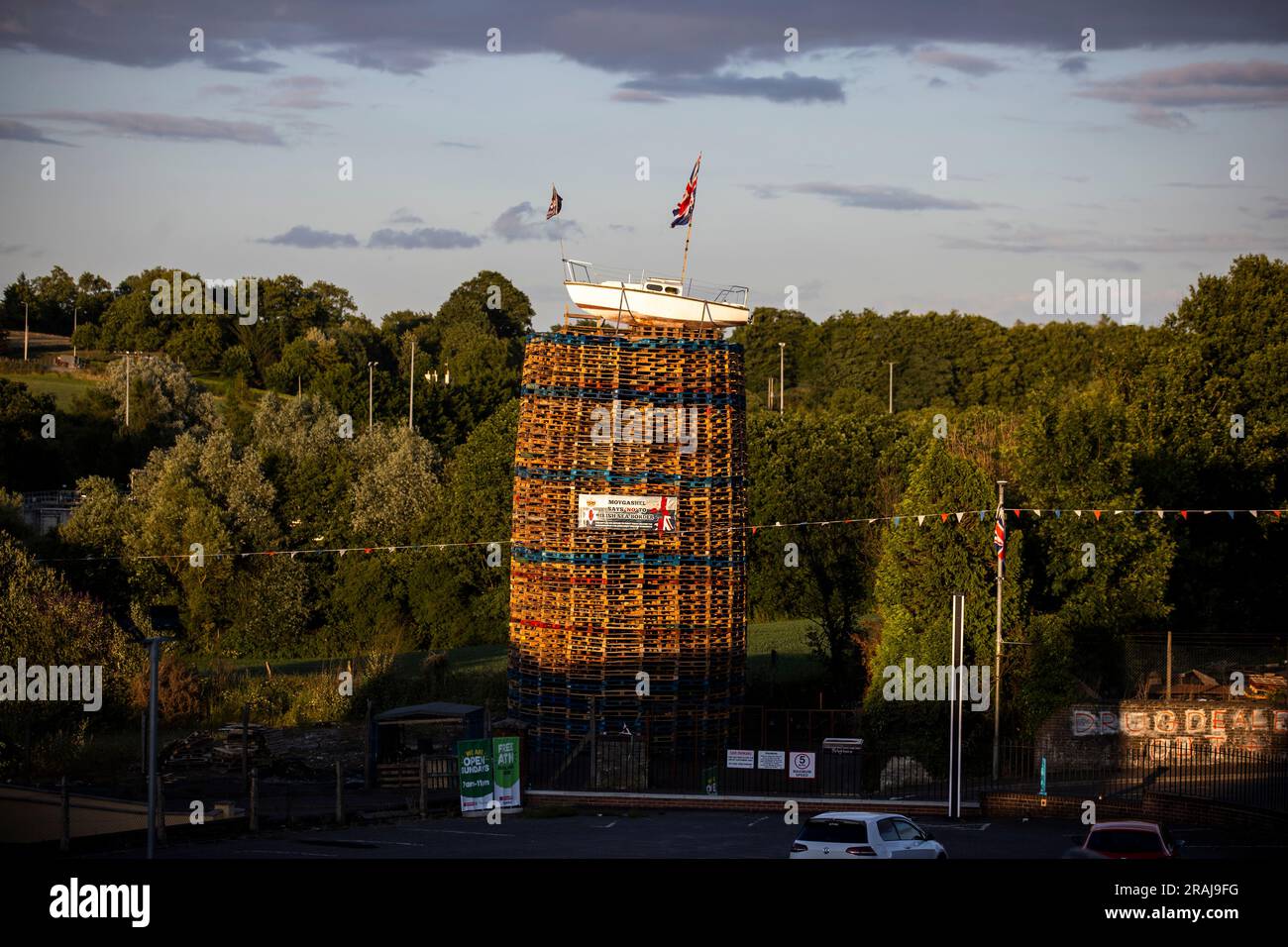 A boat flying the Union Jack flag placed on the top of the pyre with a ...