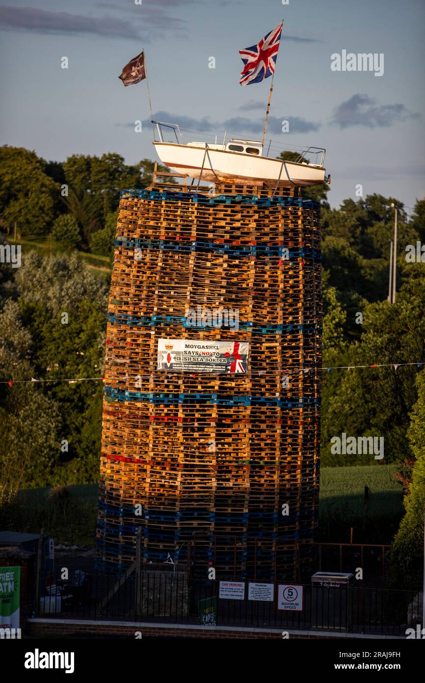 A boat flying the Union Jack flag placed on the top of the pyre with a ...