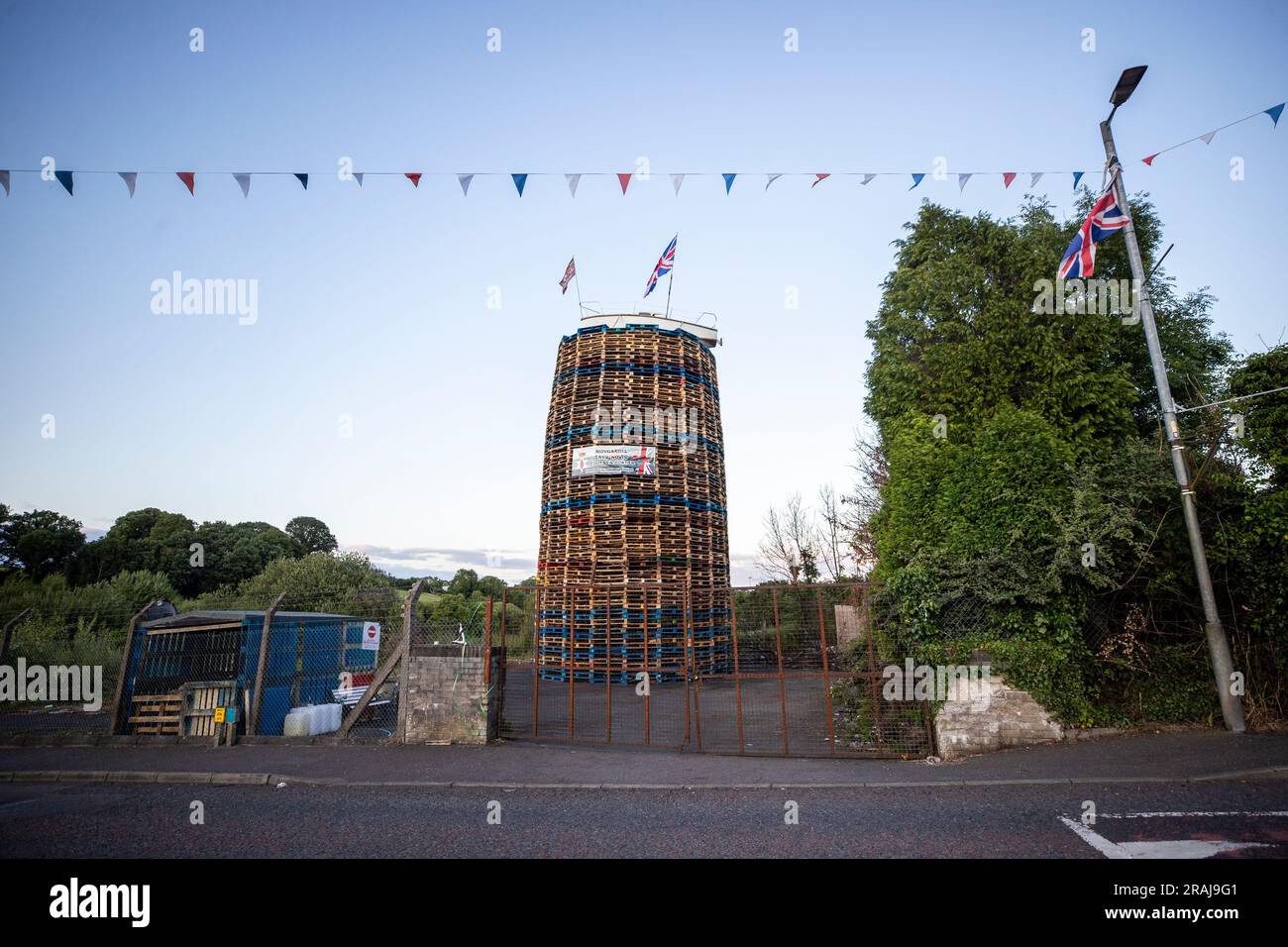 A boat flying the Union Jack flag placed on the top of the pyre with a ...