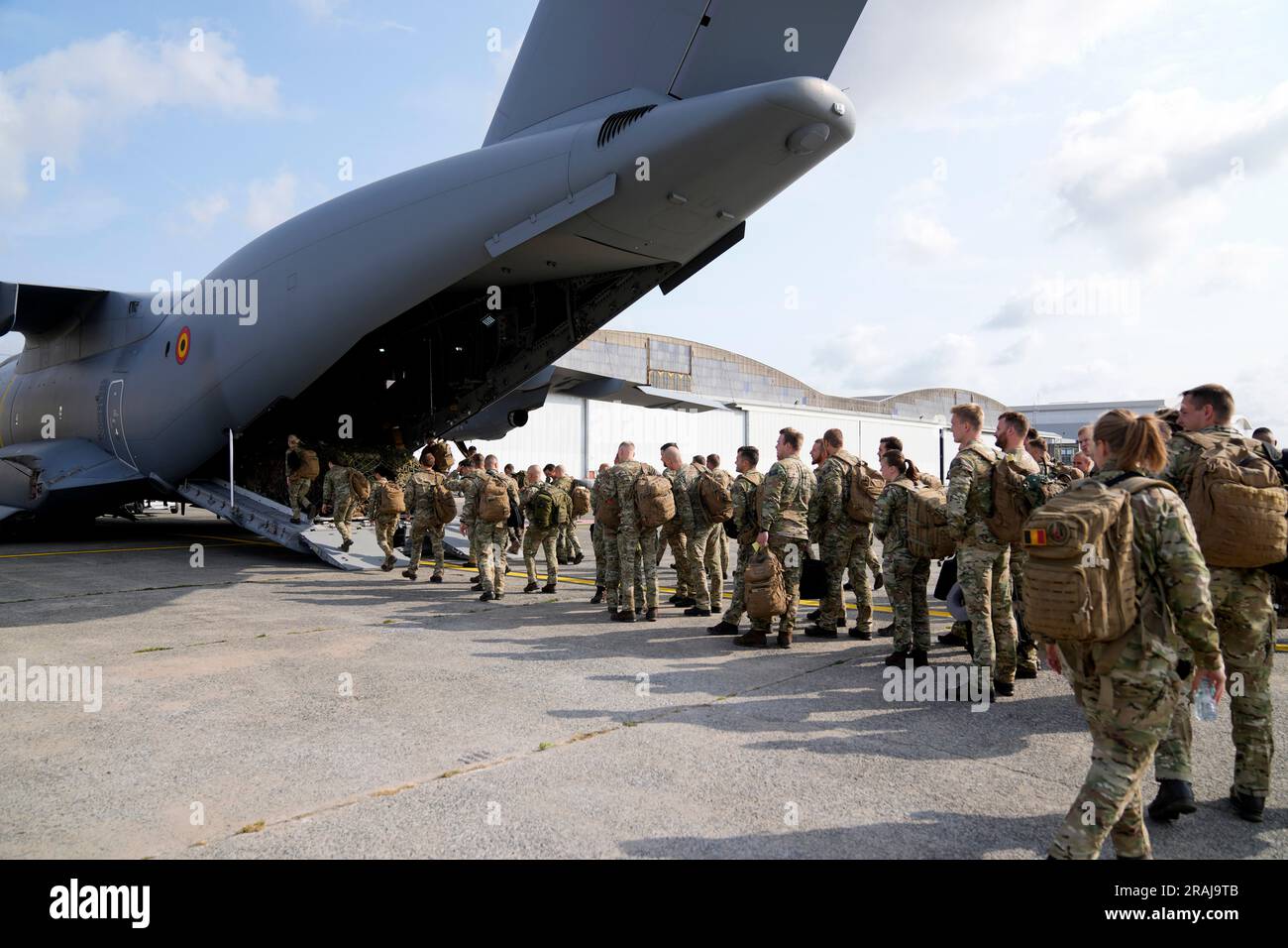 Soldiers from Belgium and Luxembourg line up to board a military ...