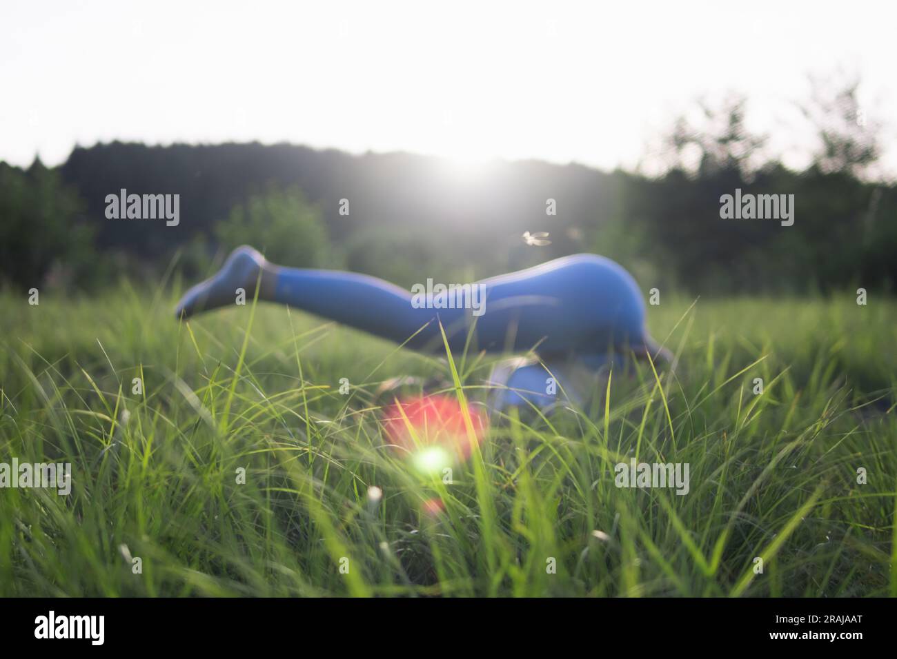 a girl in blue leggings does a stretching throwing her legs over ...