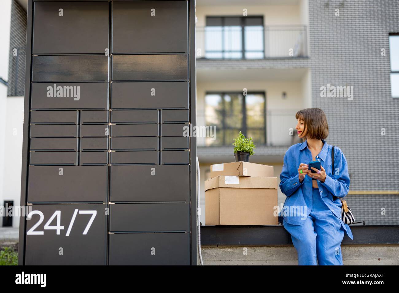 Woman with parcels near post office machine outdoors Stock Photo - Alamy