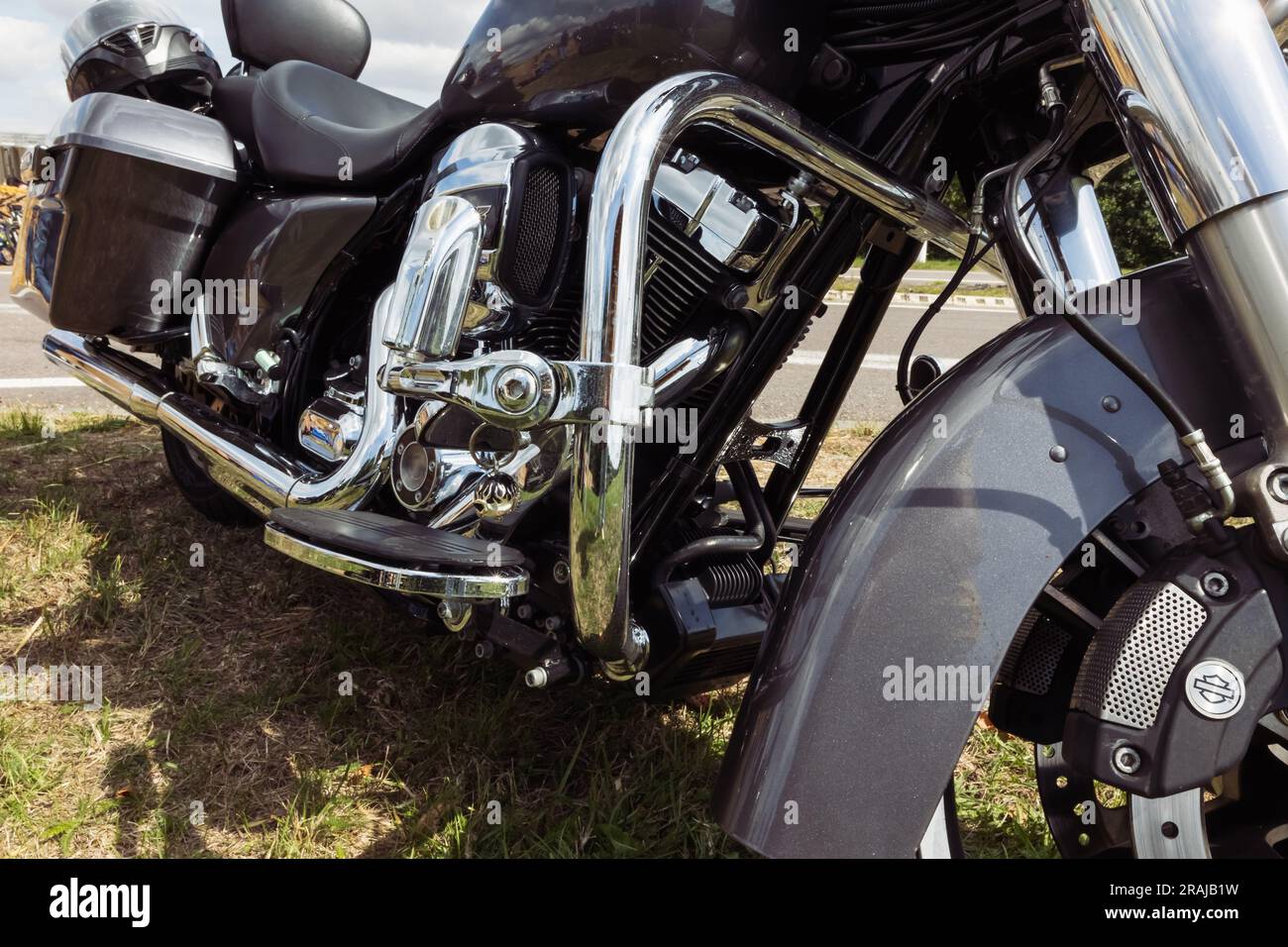 black motorcycle side view close-up ,motorcycle standing on green grass ...