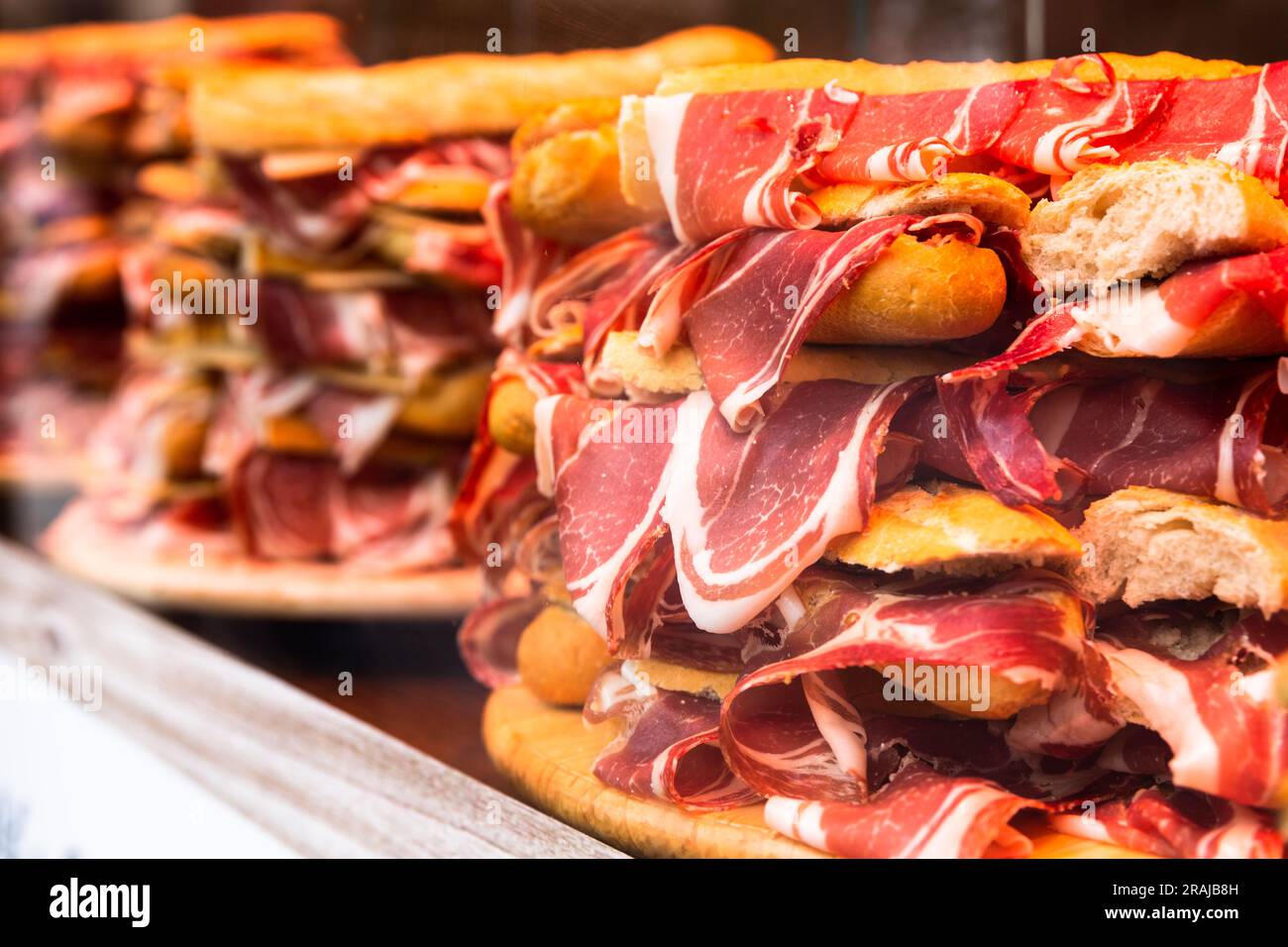 Traditional Spanish bocadillos laid out in a slide on a shop window ...