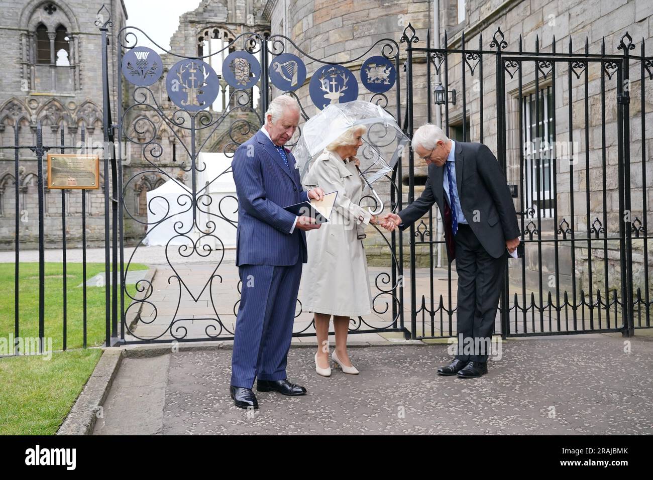 King Charles III and Queen Camilla are presented with a leather-bound ...
