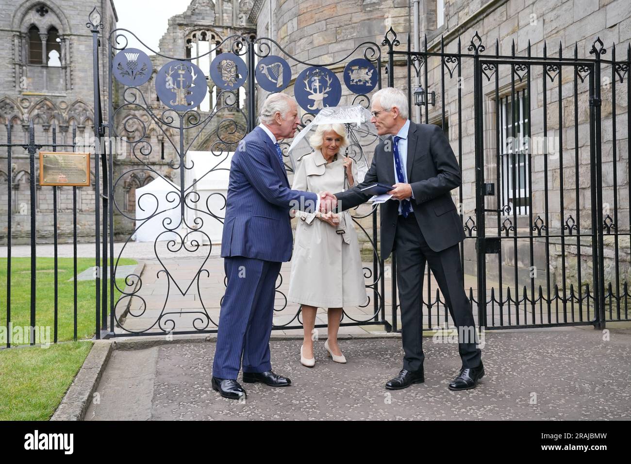 King Charles III and Queen Camilla are presented with a leather-bound ...