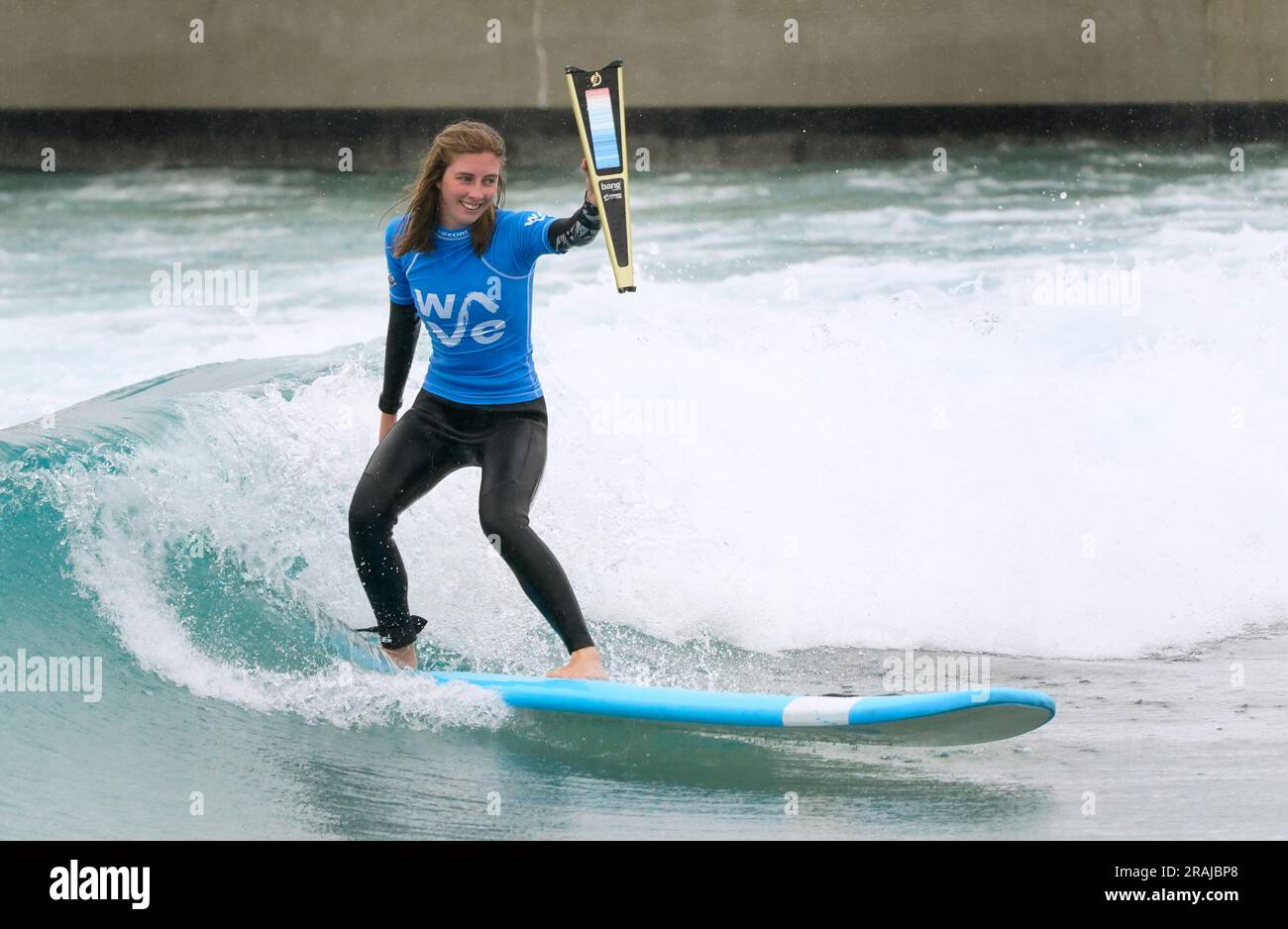 Welsh surfing champion and Wave Surf Coach, Emily Williams, holds the ...