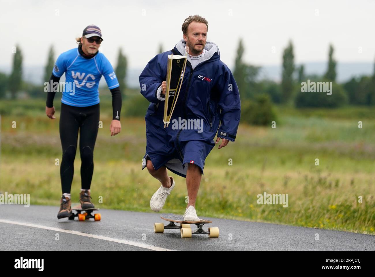 The Wave Founder, Nick Hounsfield, (right) skateboards holding the ...