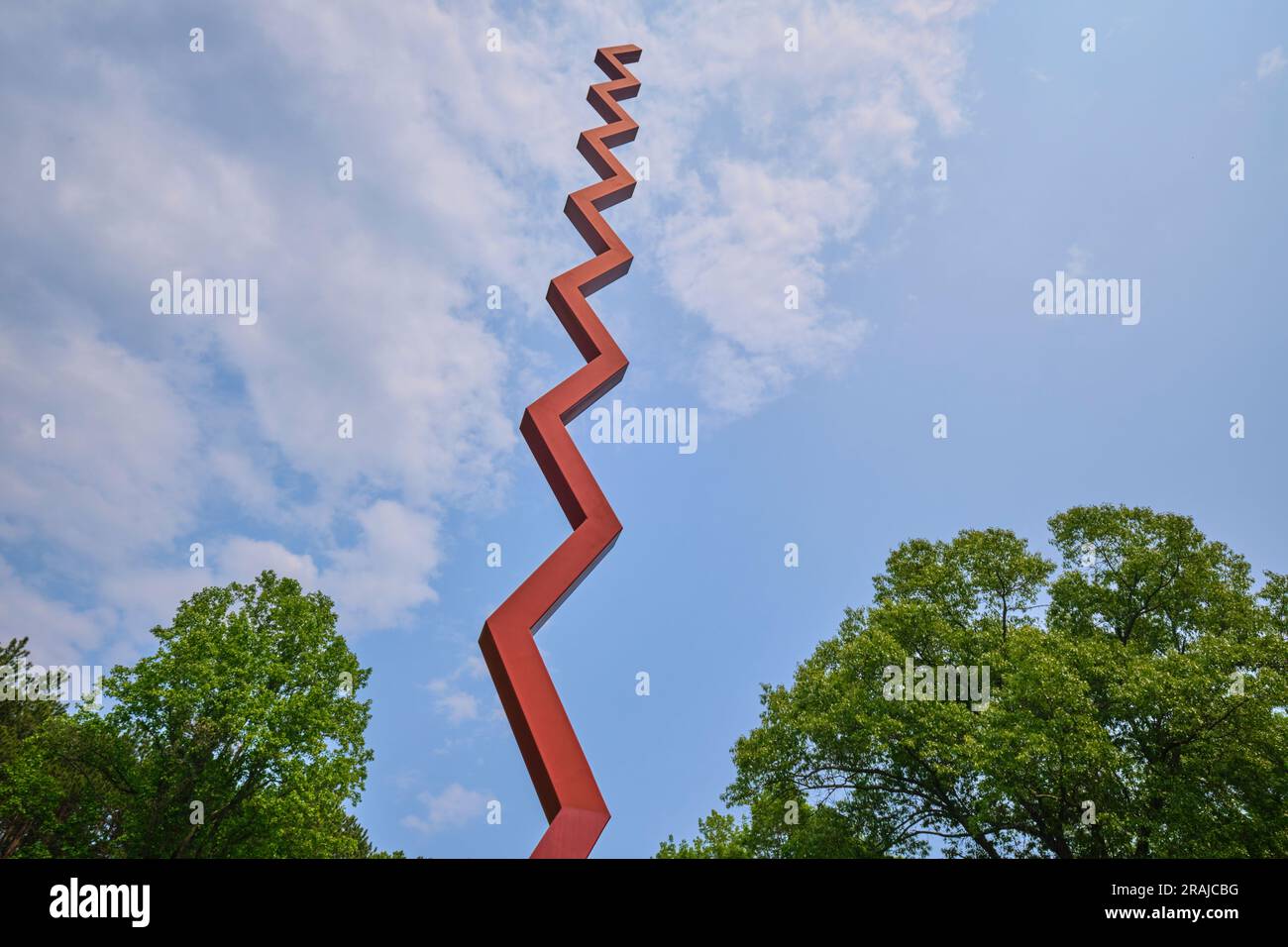 A view of the tall, red, squiggly line sculpture titled Endless Column ...