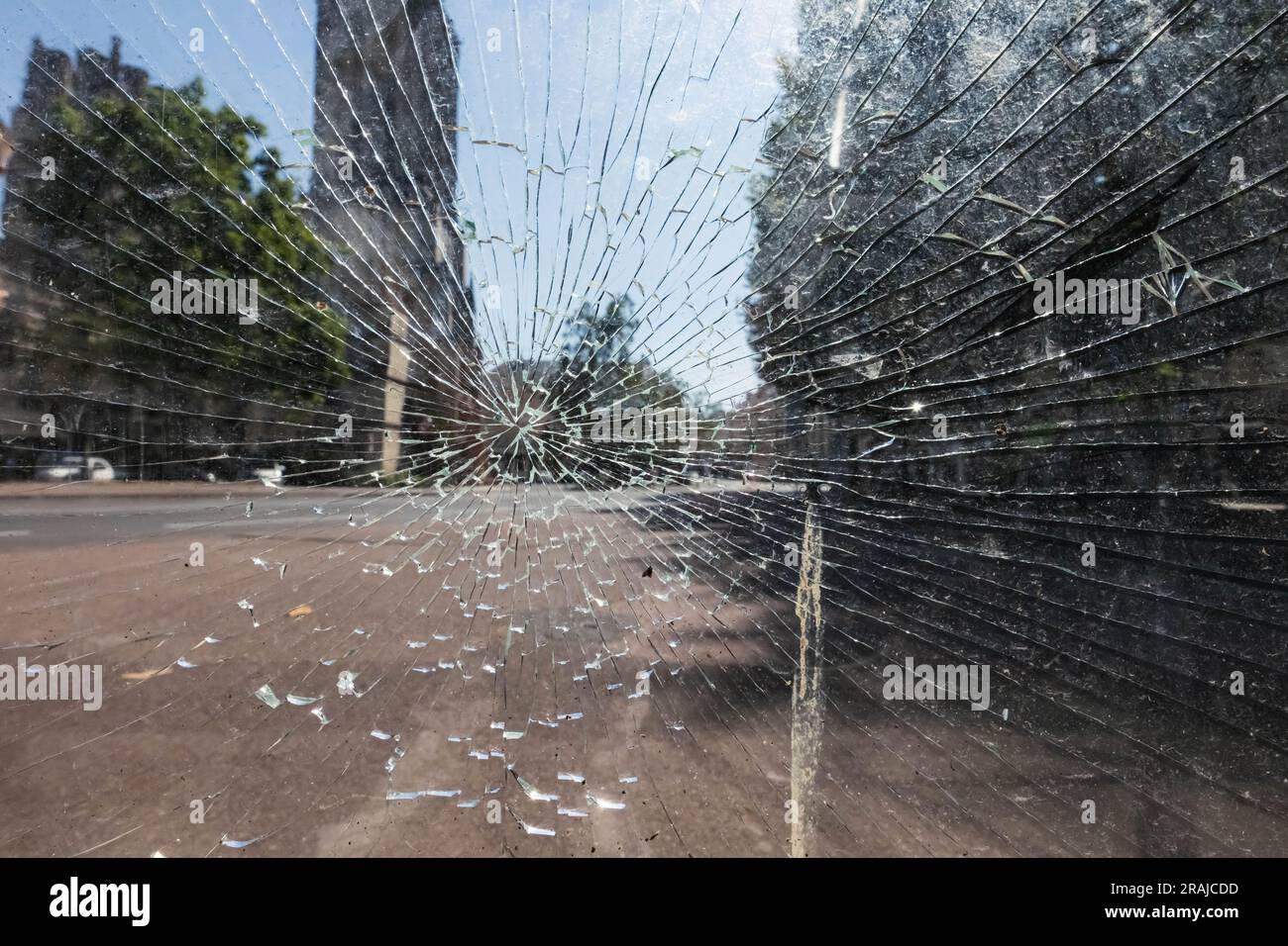 broken glass in the window, a crack went all over the glass Stock Photo - Alamy