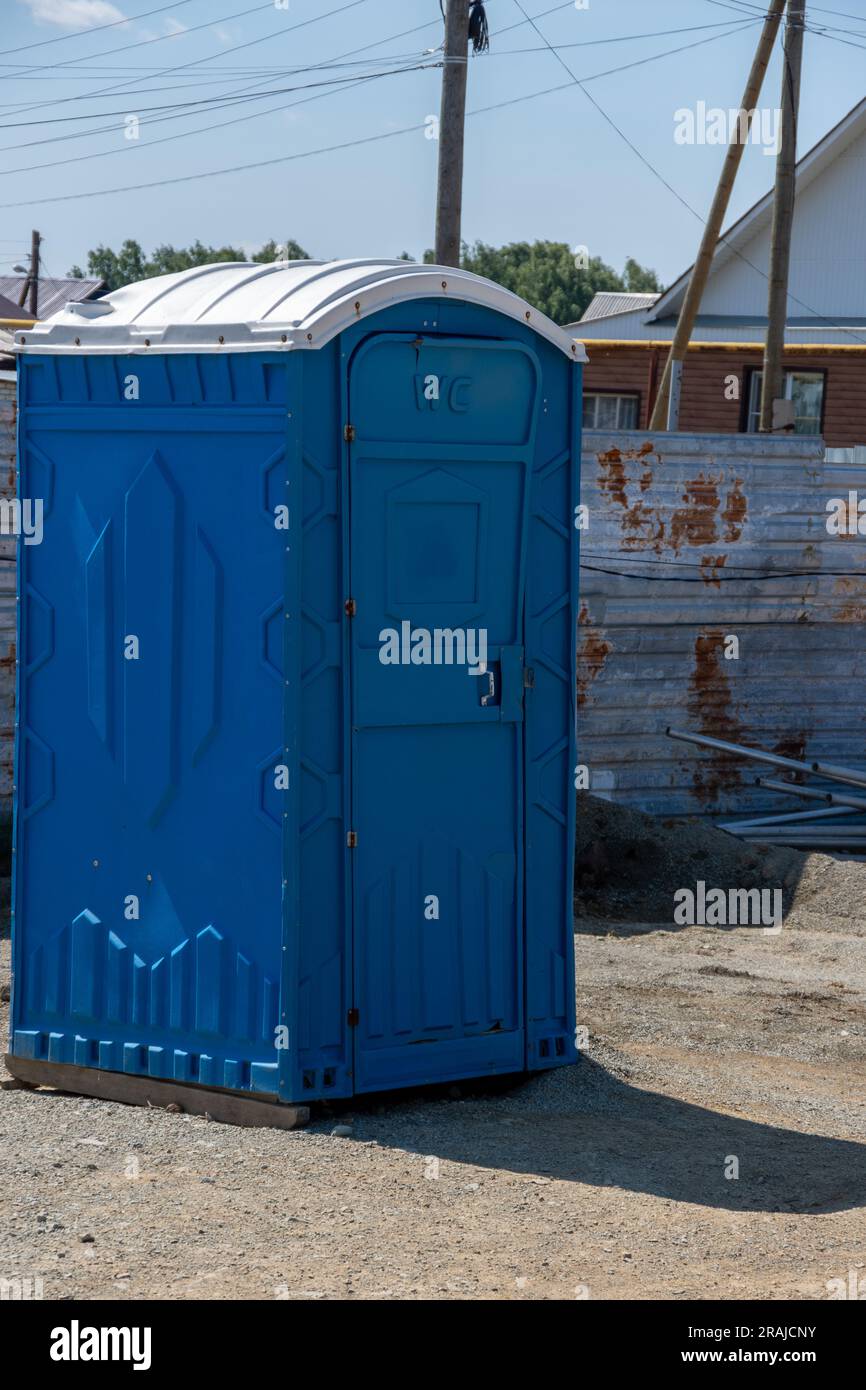 Mobile blue plastic toilet on the street. Individual hygiene products ...