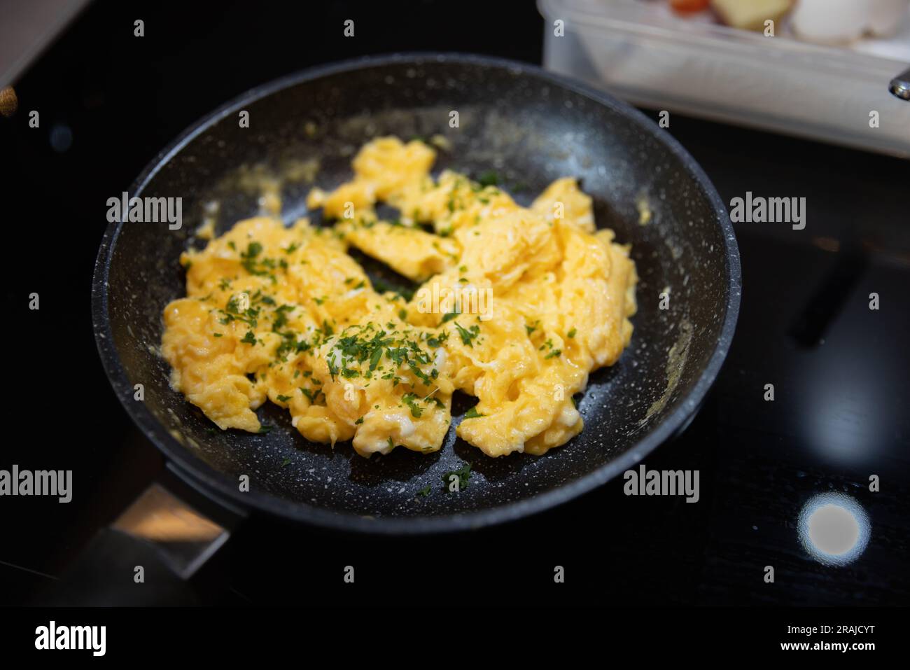 Scrambled eggs in cooking pan. Process of cooking scrambled eggs Stock ...