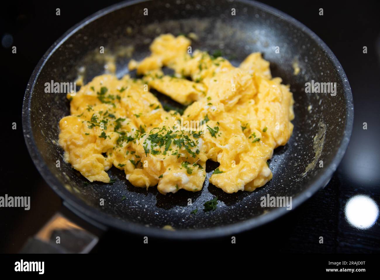 Scrambled eggs in cooking pan. Process of cooking scrambled eggs Stock ...