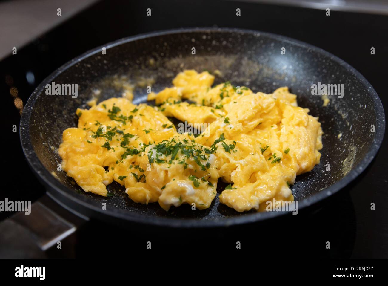 Scrambled eggs in cooking pan. Process of cooking scrambled eggs Stock ...