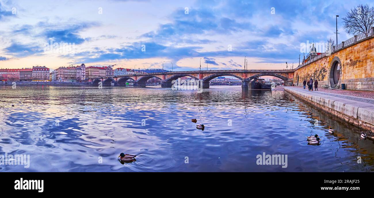 The twilight panorama of Vltava River with arched stone Palacky Bridge ...