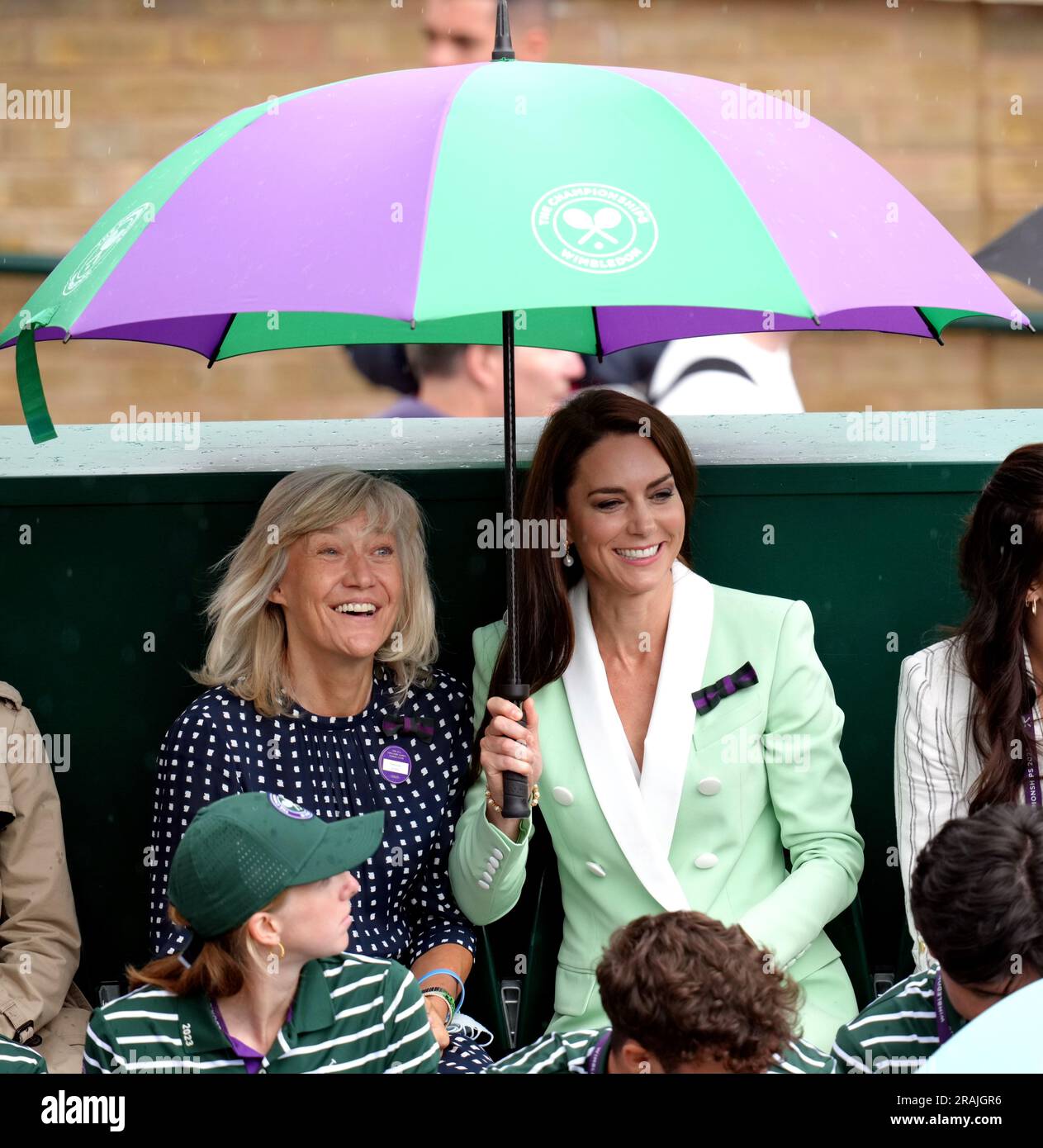 The Princess of Wales alongside Deborah Jevans (left) take shelter from ...