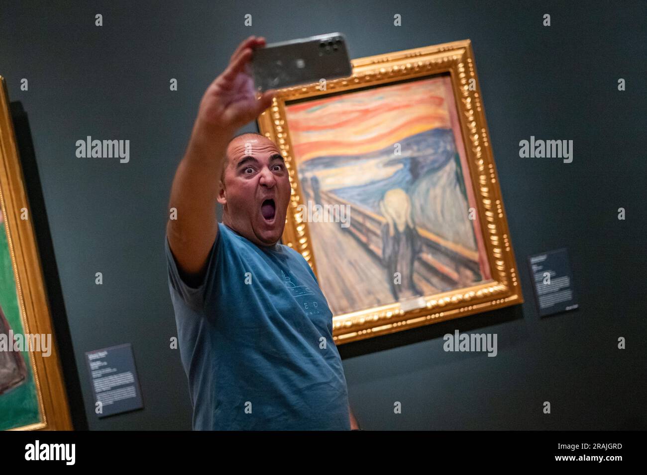 Oslo, Norway, June 20, 2023: A tourist observes the famous Edvard Munch ...