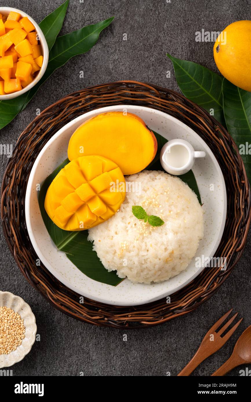 Delicious Thai mango sticky rice with cut fresh mango fruit in a plate ...
