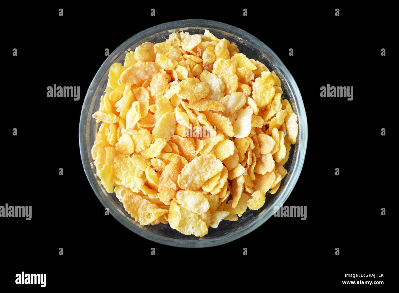 Bowl of corn-flakes isolated on black background Stock Photo - Alamy