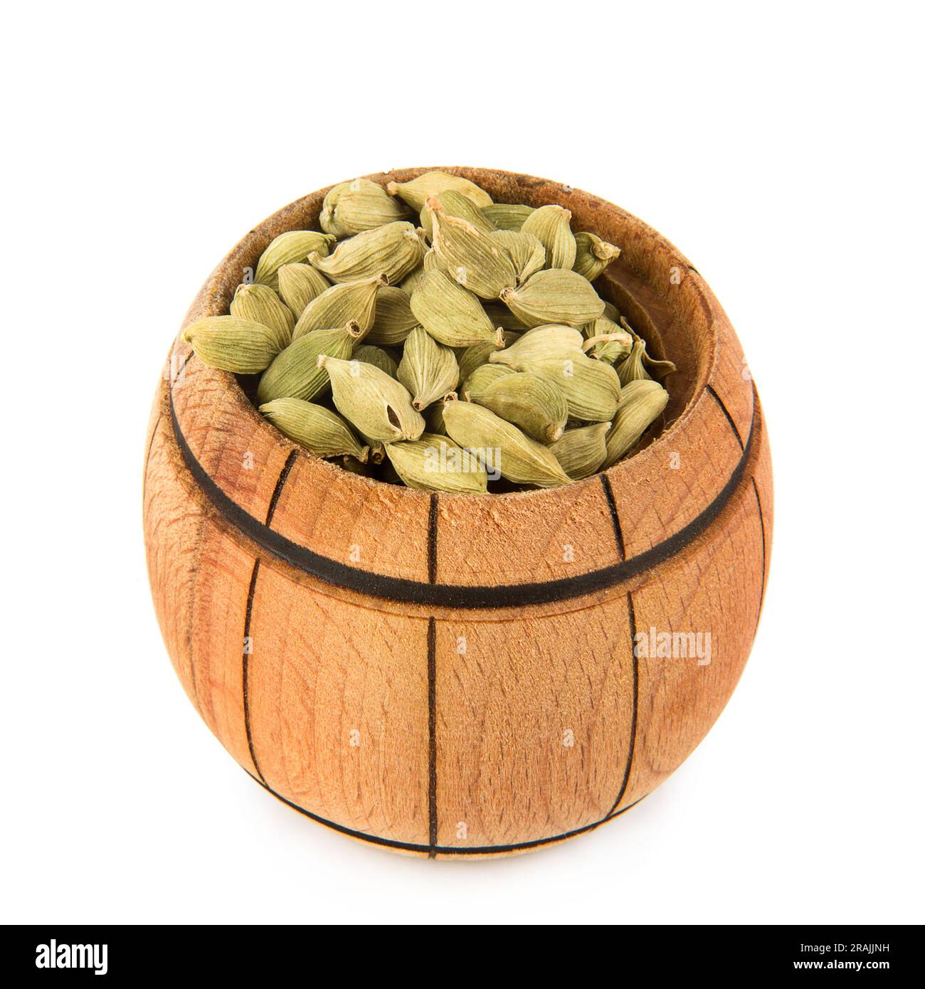 Cardamom in a wooden bowl isolated on white background Stock Photo - Alamy
