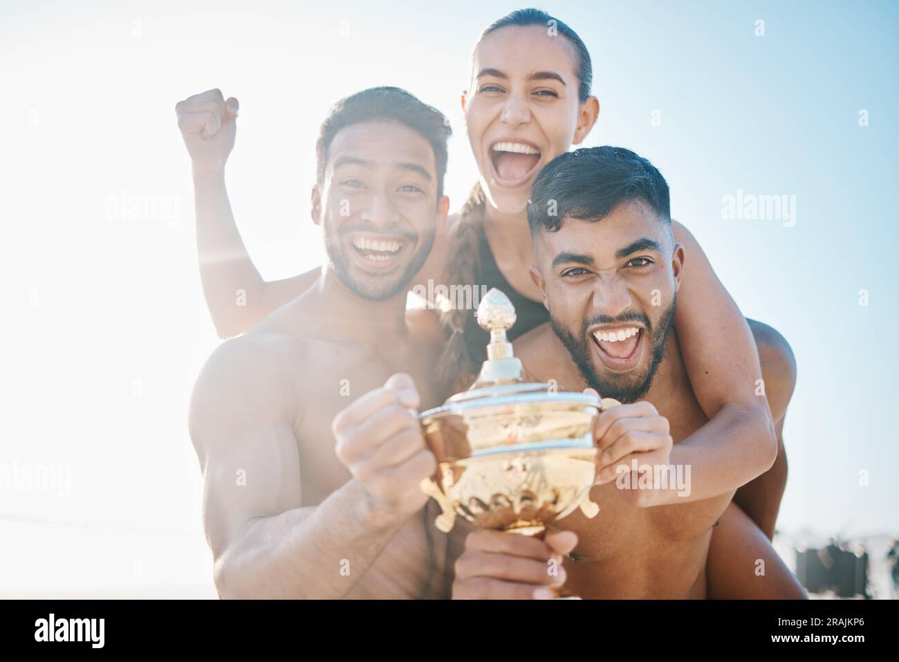 Winning, portrait and volleyball team on the beach with a trophy for ...