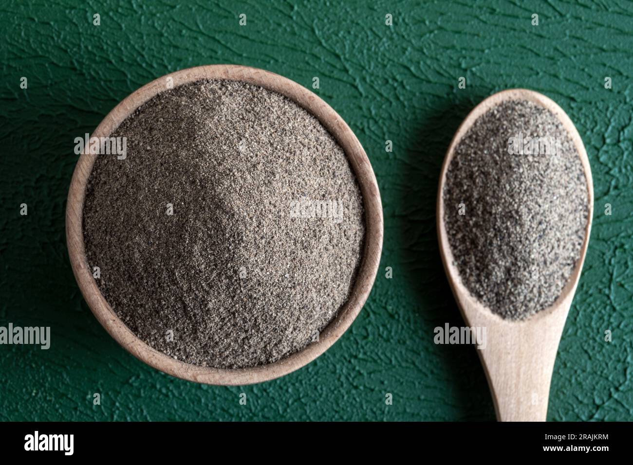 Powder black pepper green background top view Stock Photo - Alamy