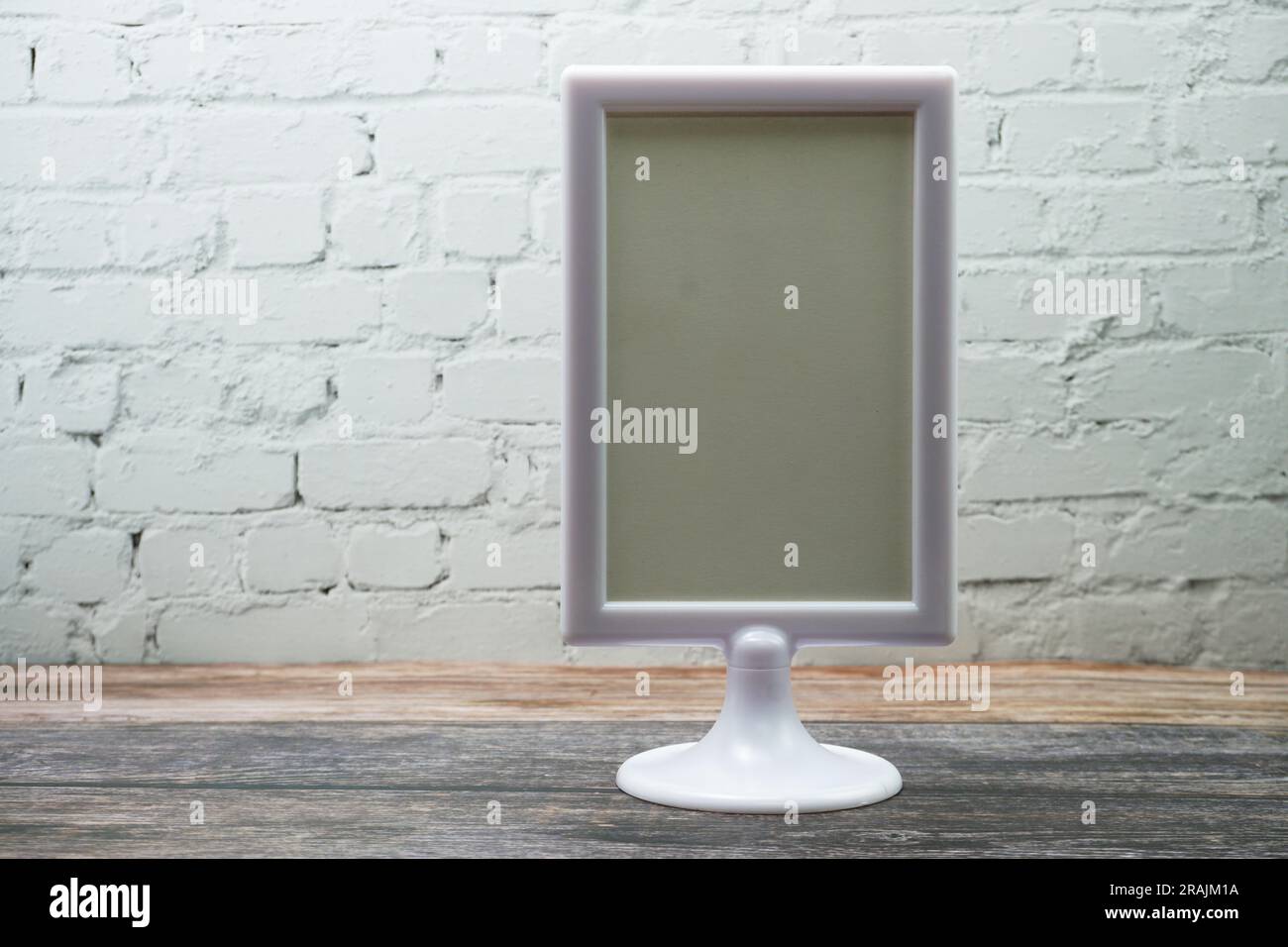 Blank Display frame stand on wooden background Stock Photo - Alamy