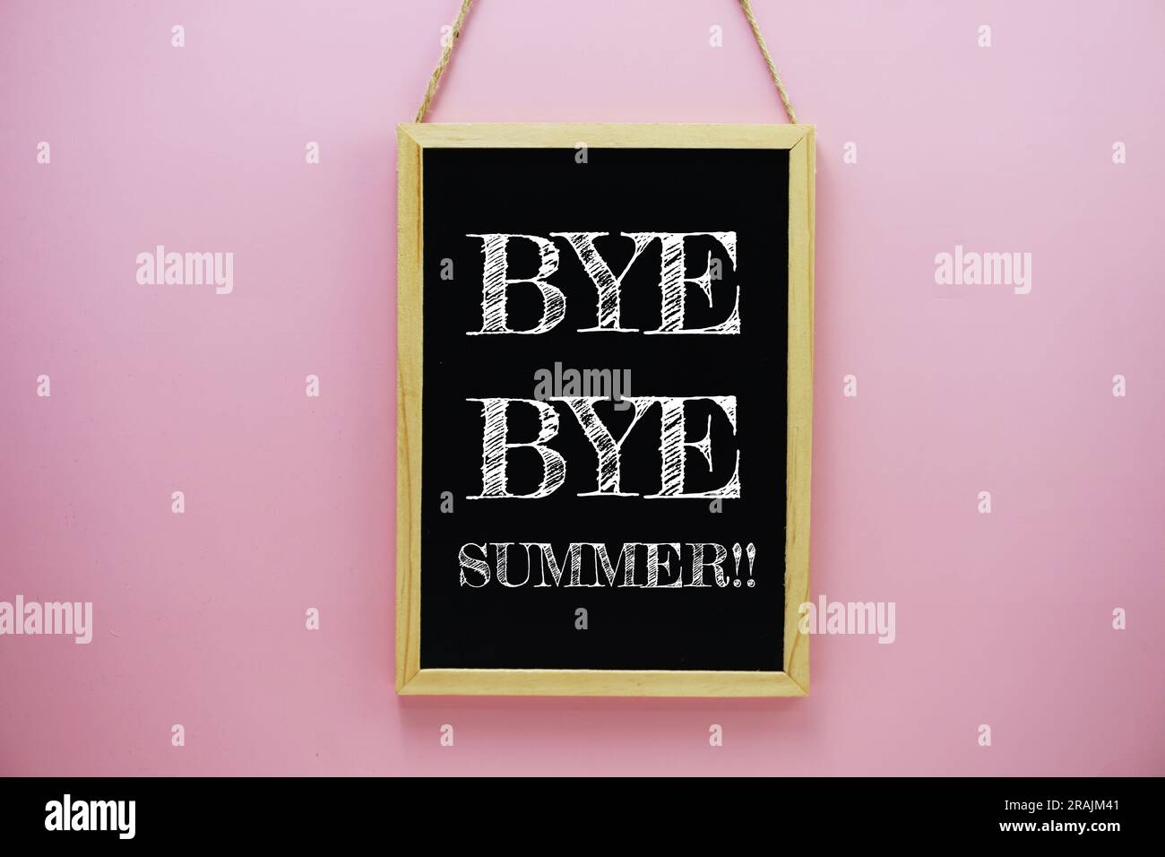 Bye Bye Summer typography text on wooden blackboard hanging on pink ...