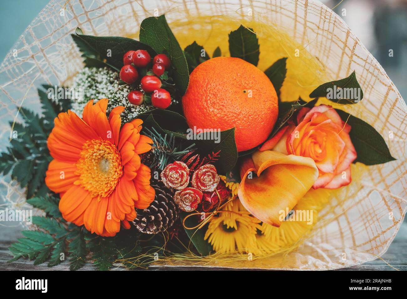 Christmas flower bouquet, orange and yellow flowers with pine, candle ...