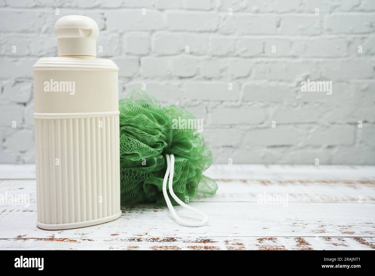 Shower Bottle and Shower Puff Fibre Scrub Stock Photo - Alamy