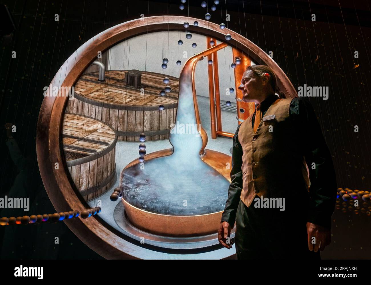 Tour guide at new immersive visitor media image projection about whisky ...
