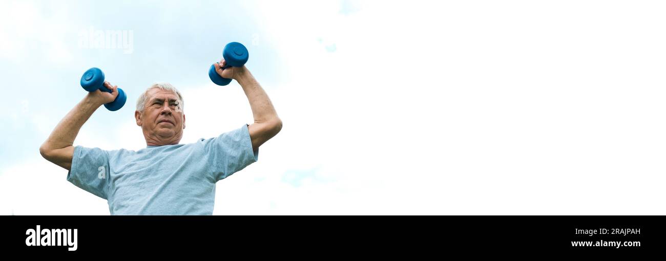 Senior man working out outdoor. Person lifting dumbbells. Old male ...