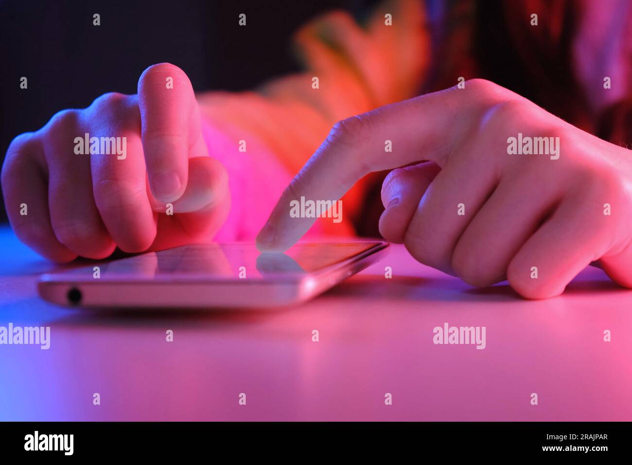 Use of mobile phone in trendy neon lights. Creative vivid color of ...