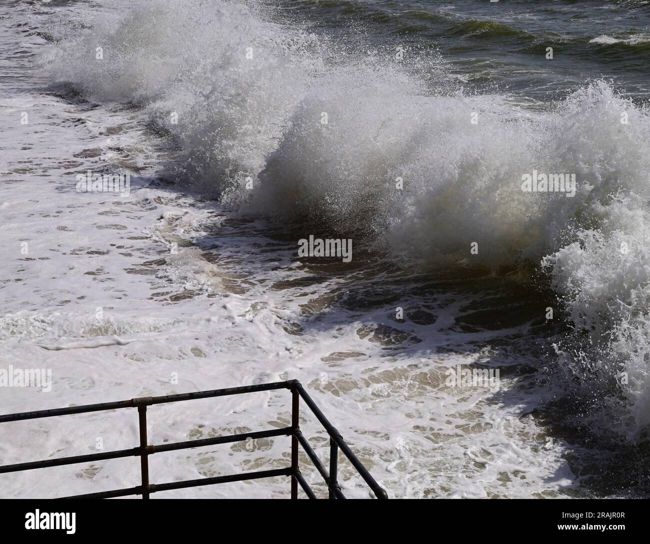 Waves and railings along the seawall at Dawlish, South Devon Stock ...