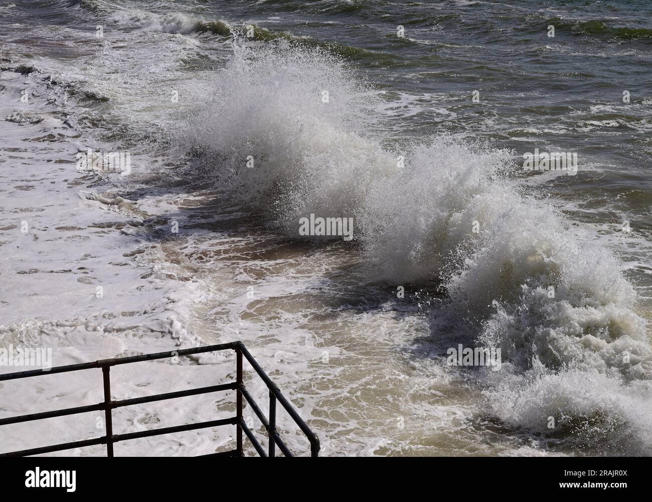 Waves and railings along the seawall at Dawlish, South Devon Stock ...
