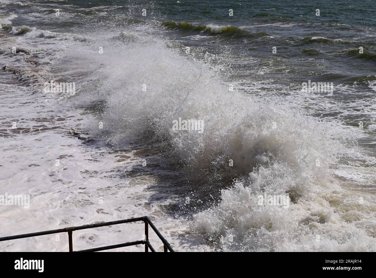 Waves and railings along the seawall at Dawlish, South Devon Stock ...