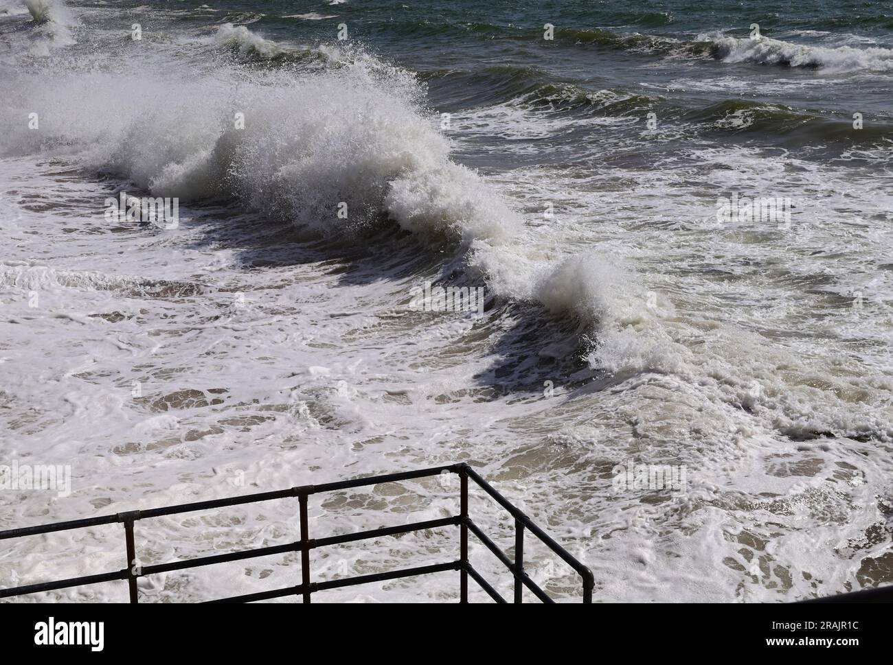 Waves and railings along the seawall at Dawlish, South Devon Stock ...