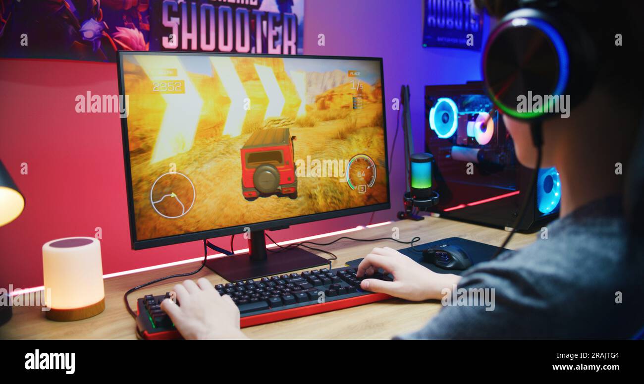 Young gamer plays in car driving simulator on PC at home. Computer ...