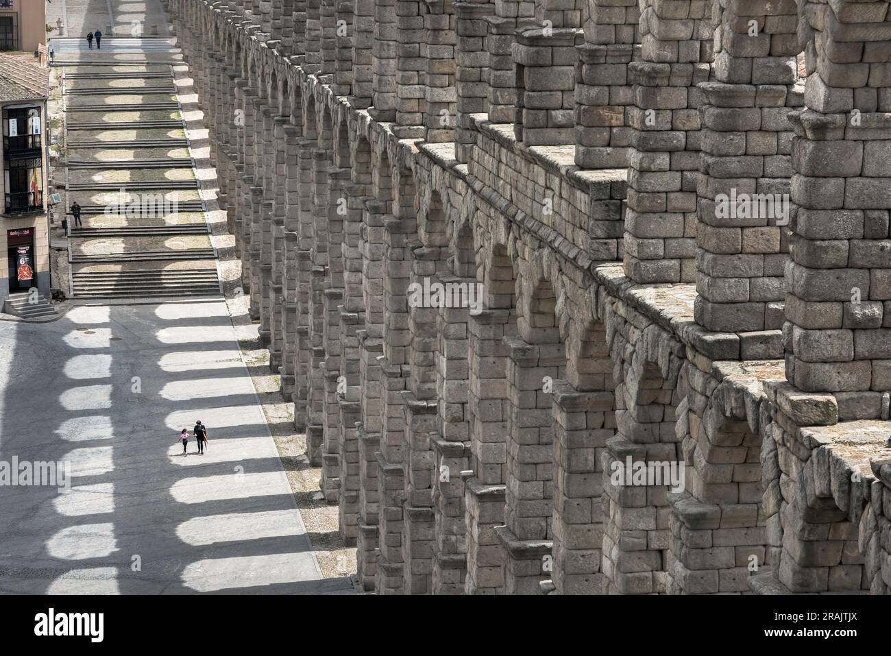 Segovia aqueduct Spain, view in summer of shadows cast by the arches of ...
