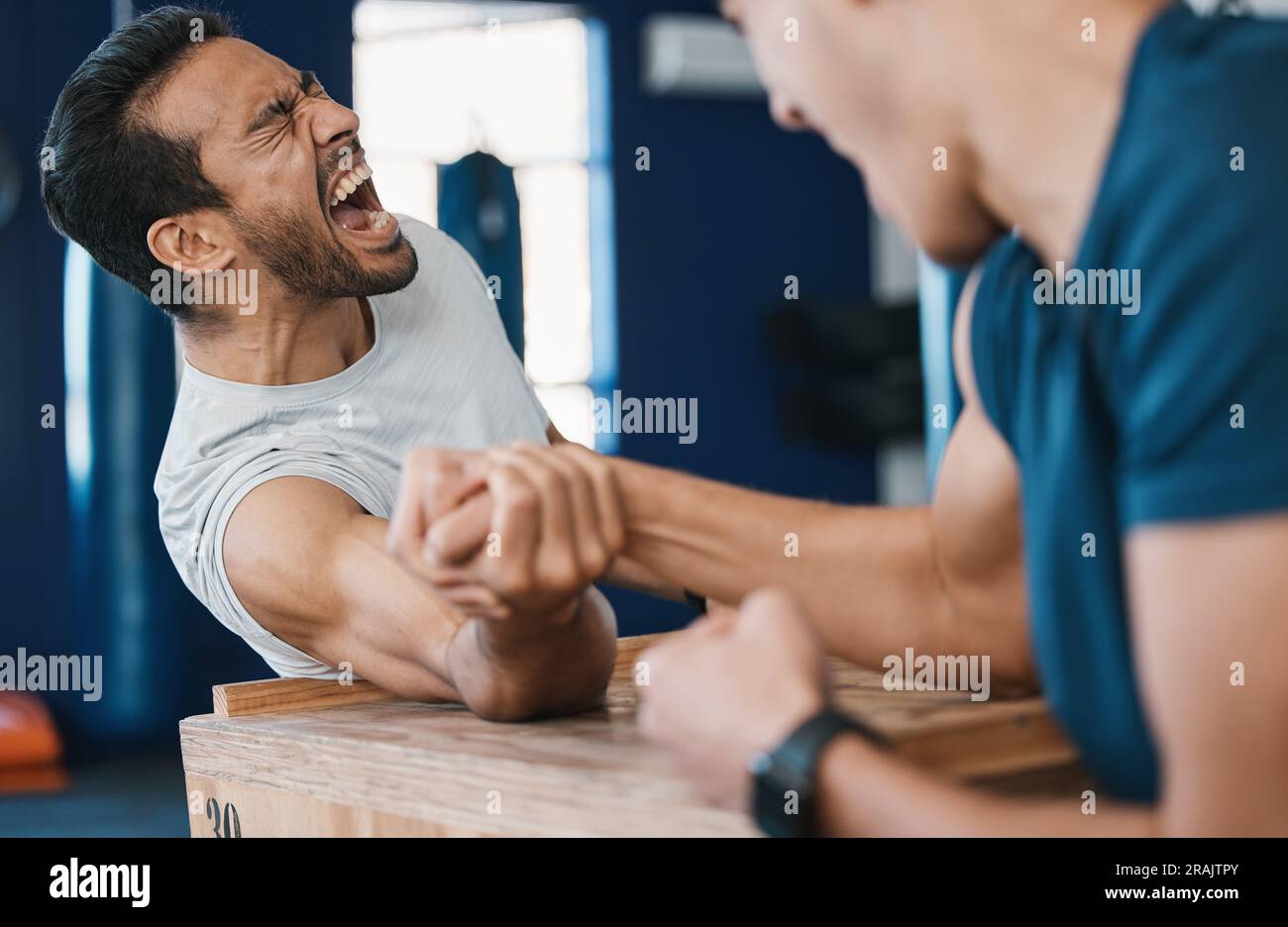 Strong, loser or men arm wrestling at gym on a table in playful ...