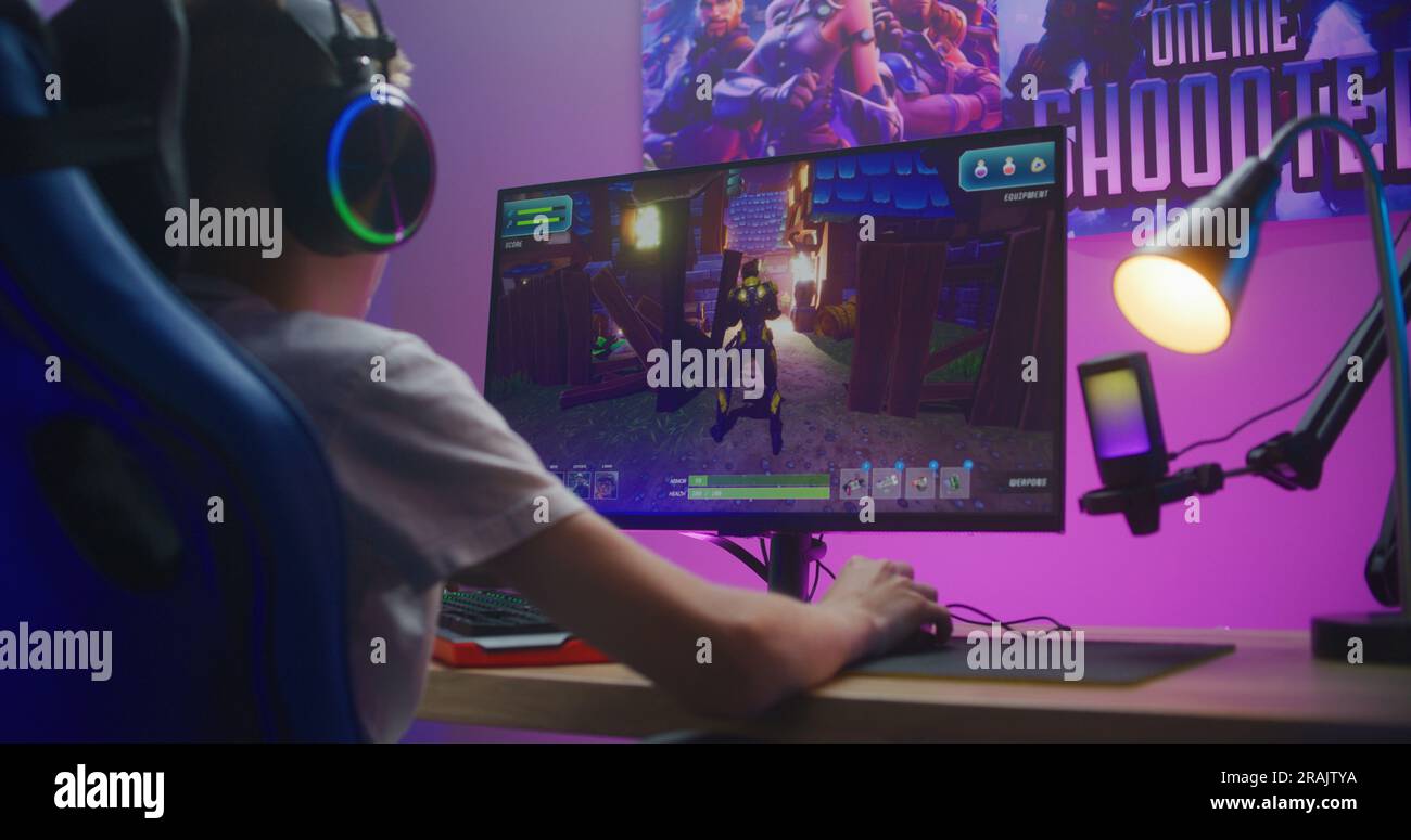 Happy gamer in headphones wins a round in online video game on home ...